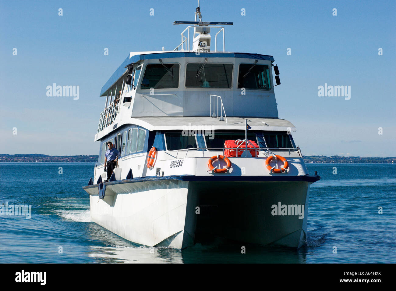 A catamaran passenger ferry approaching the harbour Bardolino Lake ...