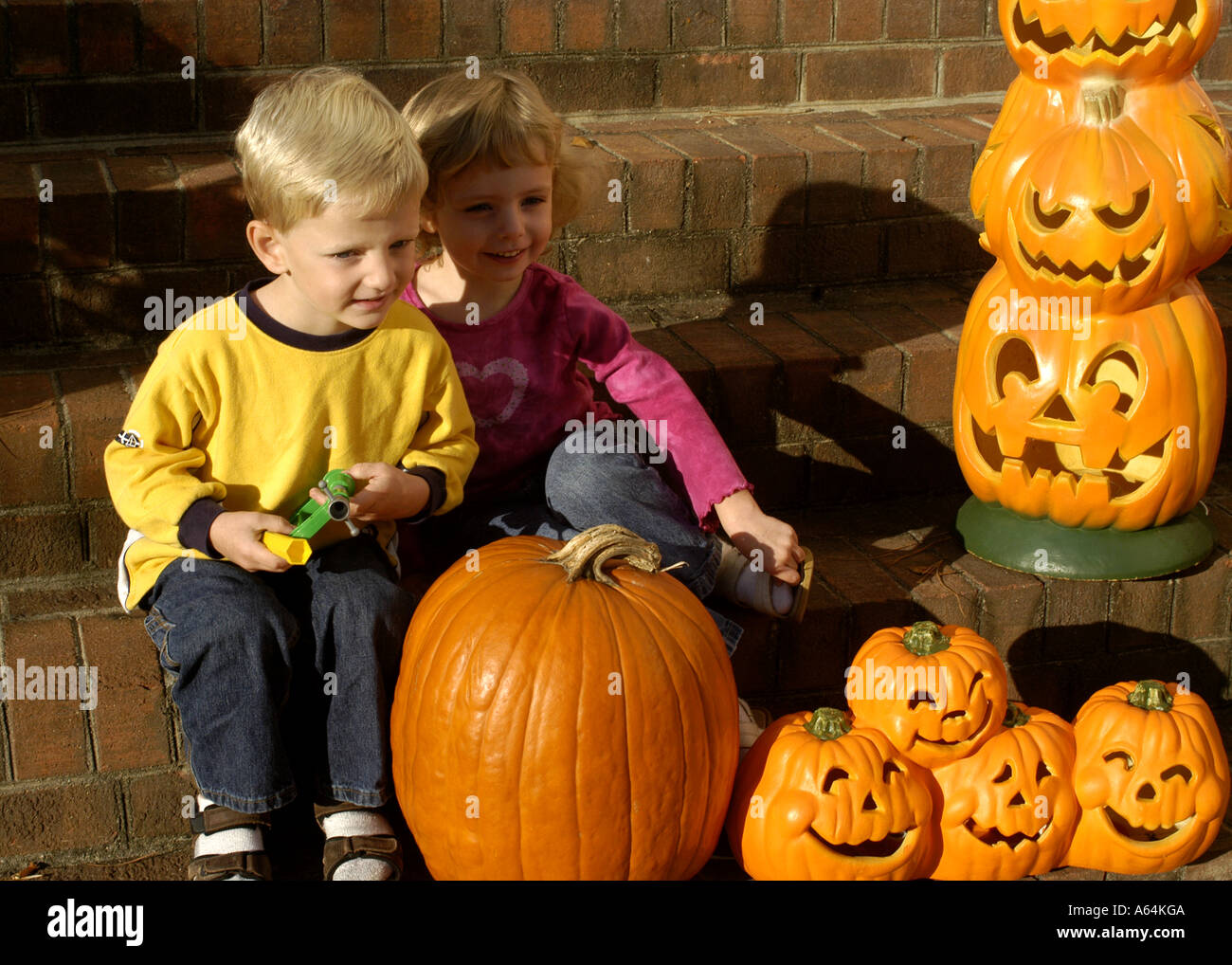 Halloween young girl boy pumpkins Stock Photo - Alamy