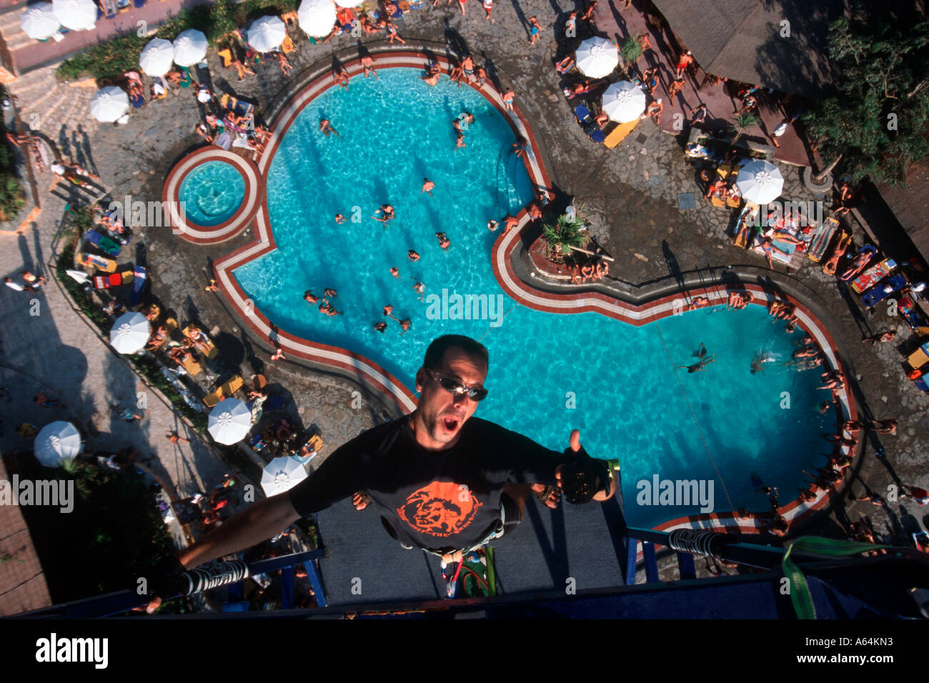 Bungee instructor on bungee platform over swimming pool at Punda Beach ...