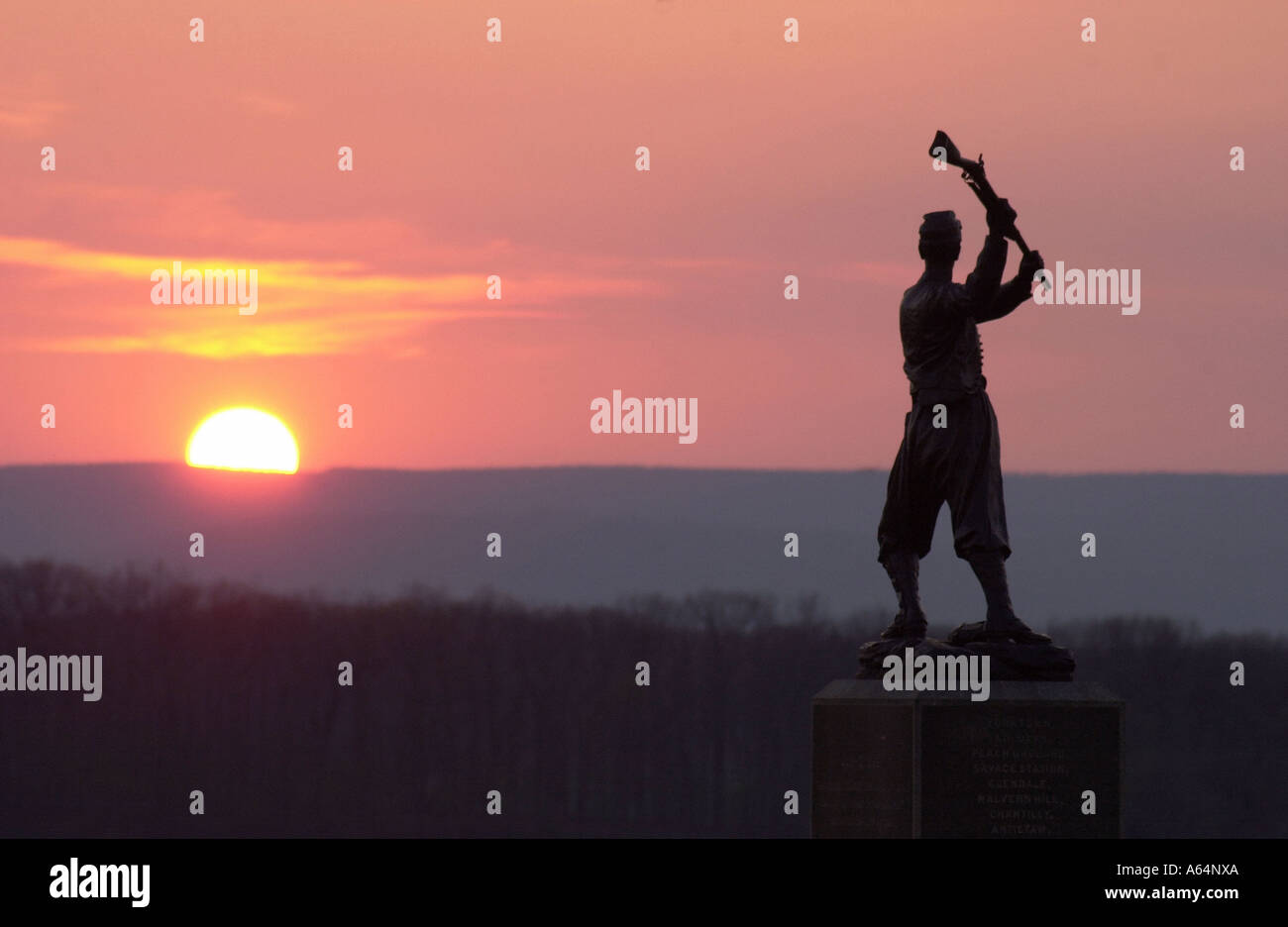 Memorial statue of a Civil War soldier on Cemetery Ridge at sunset on ...
