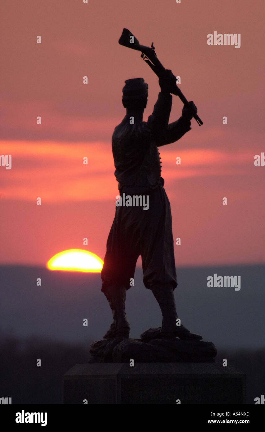 Memorial statue of a Civil War soldier on Cemetery Ridge at sunset on ...