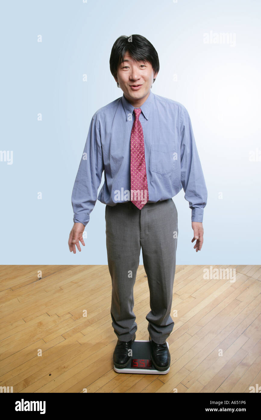 Fat man on scale hi-res stock photography and images - Alamy