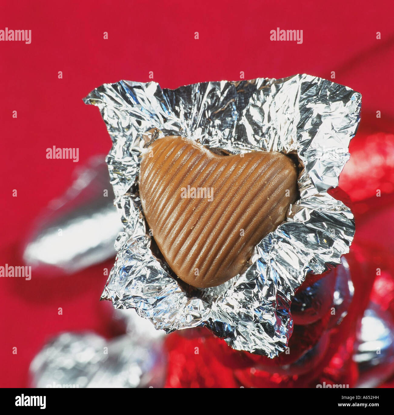 A single chocolate heart unwrapped from its foil Stock Photo - Alamy
