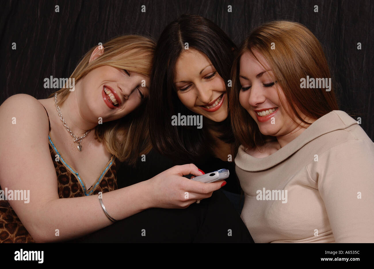 Teenagers looking at text message Stock Photo - Alamy