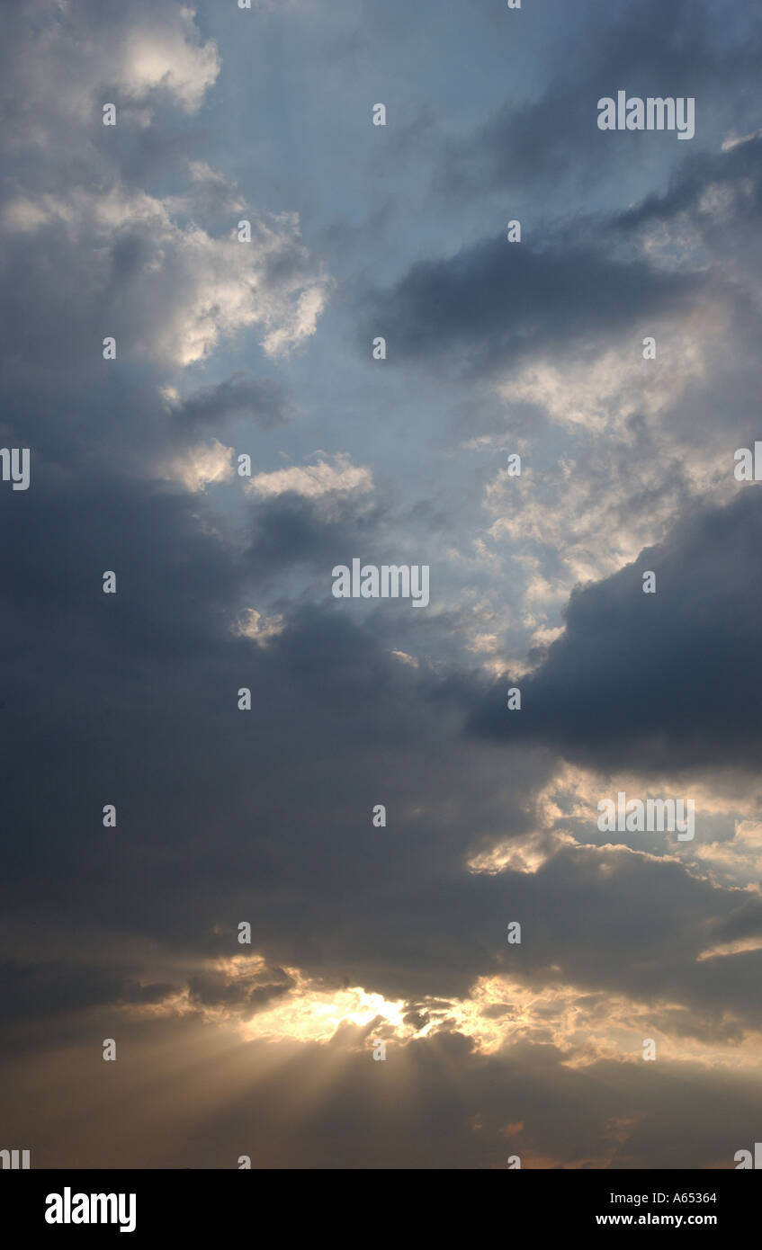 sun rays breaking through clouds in sky Stock Photo - Alamy