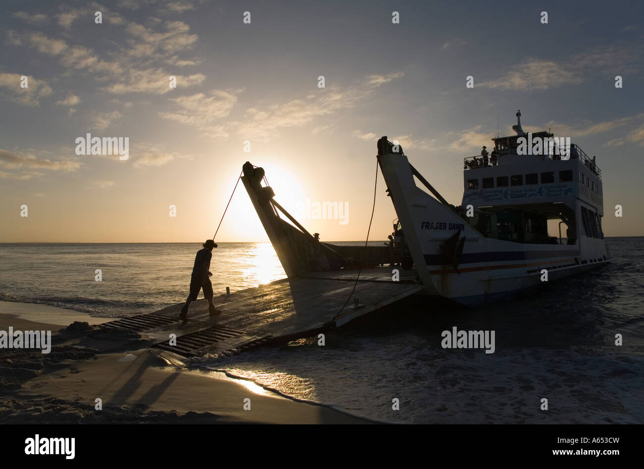 A man walks aboard the Fraser Dawn - a car ferry that transports ...