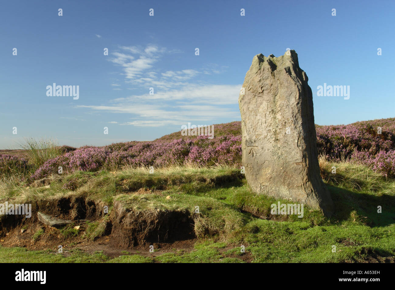 Large waymark stone with surveyors Bench Mark carved into its face ...