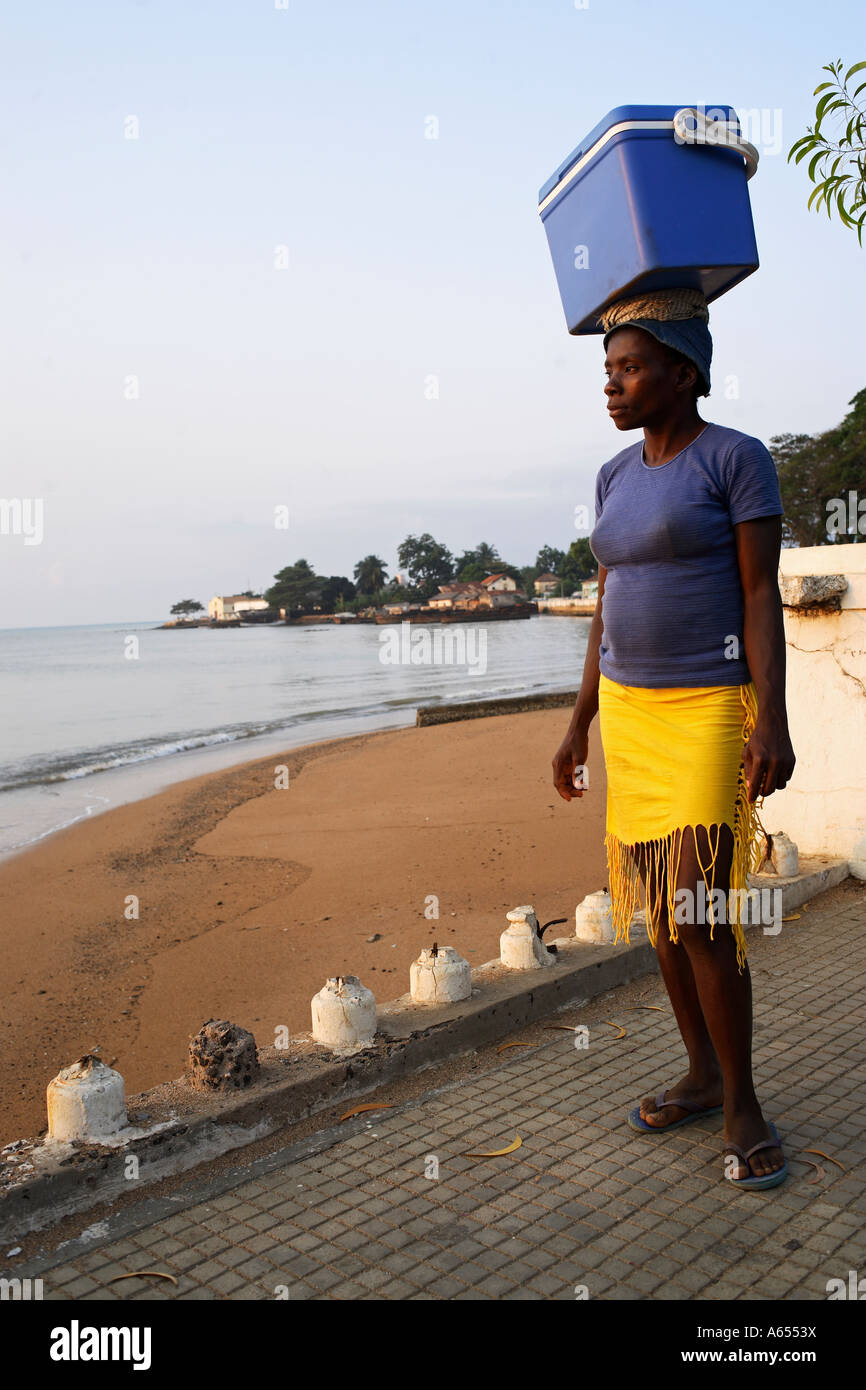 A street seller walks along the Baia de Ana Chaves Bay of Ana Chaves ...