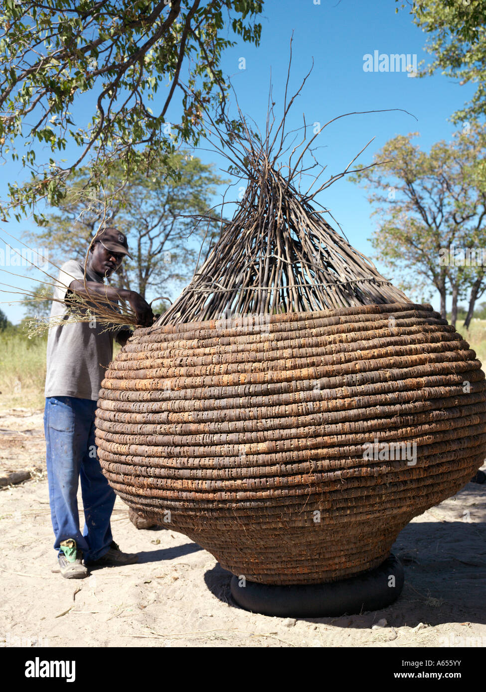 A traditional oval shaped granary being made from brushwood bound with ...