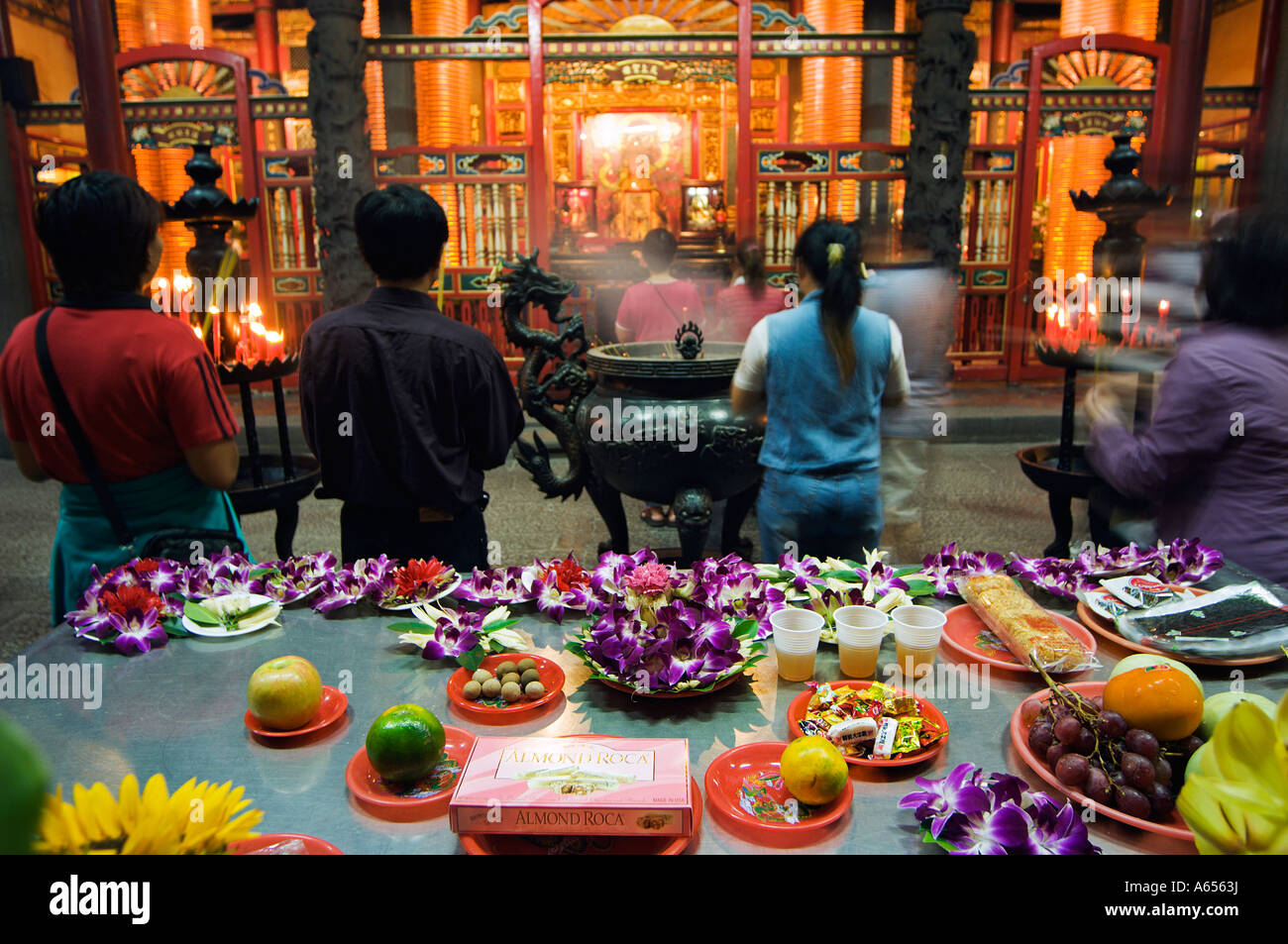 Longshan Temple worshippers and food and flower offerings Stock Photo ...