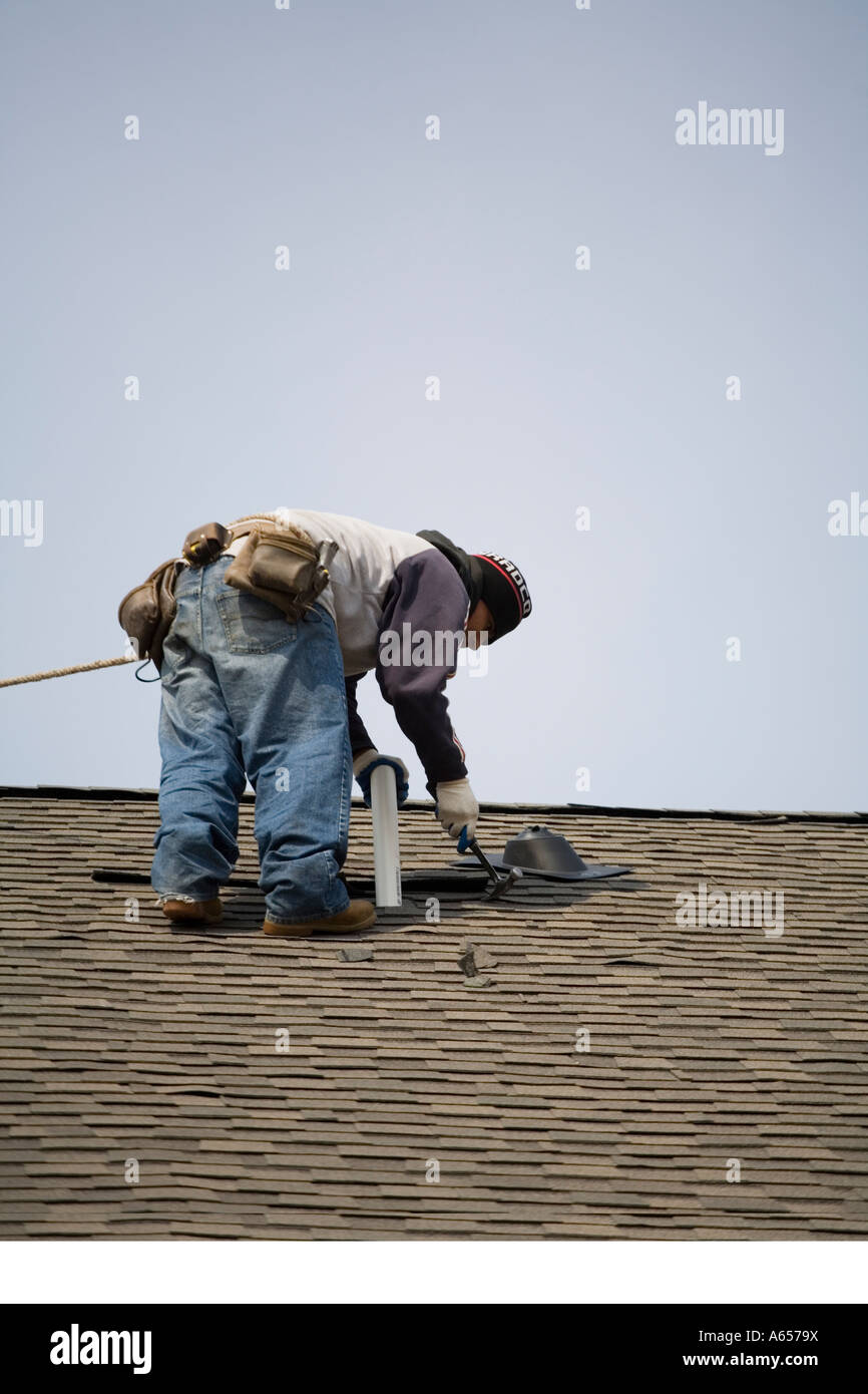 Immigrant Construction Worker Working on the Roof Stock Photo - Alamy