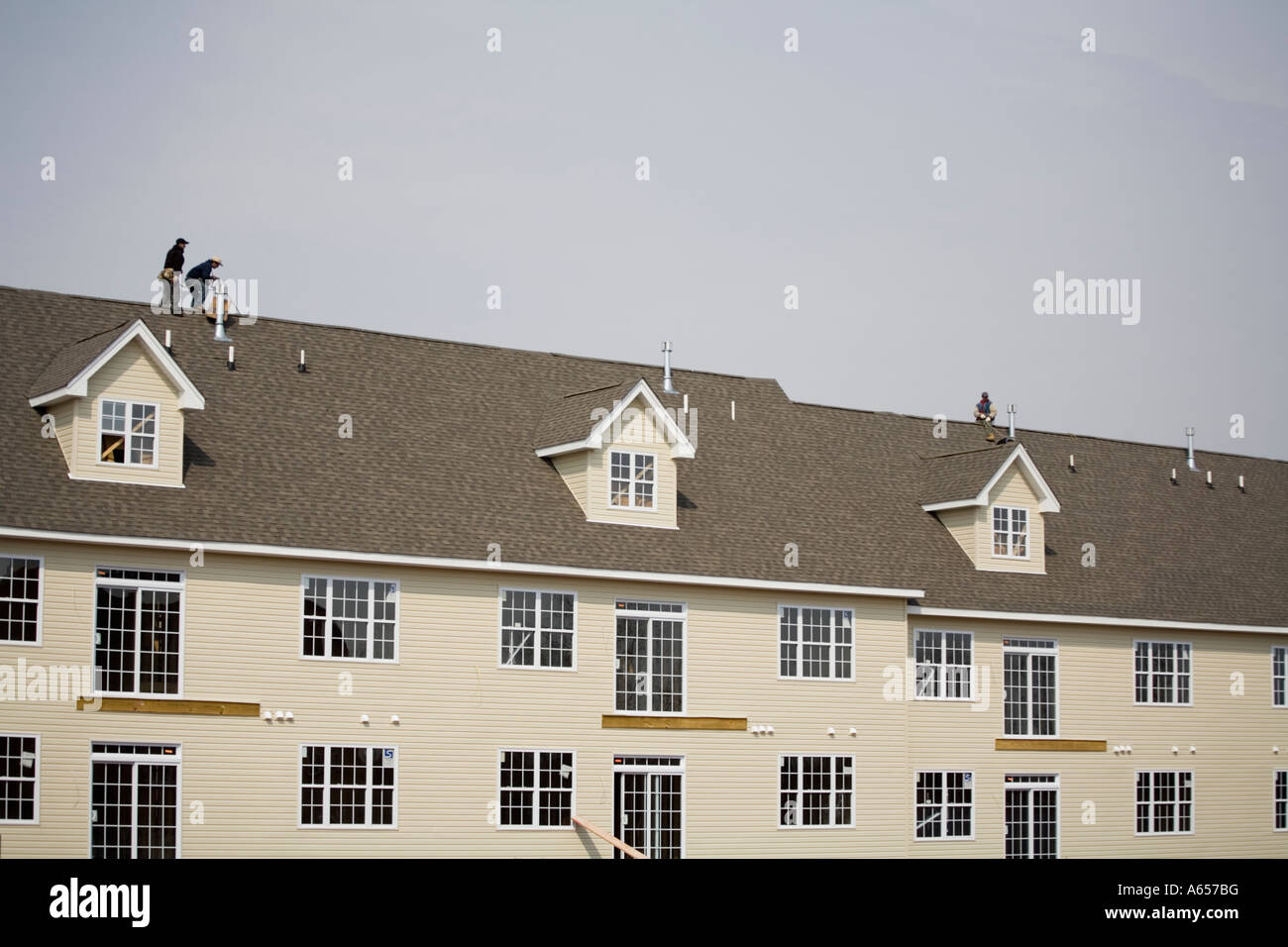 Immigrant Construction Worker Working on the Roof Stock Photo - Alamy