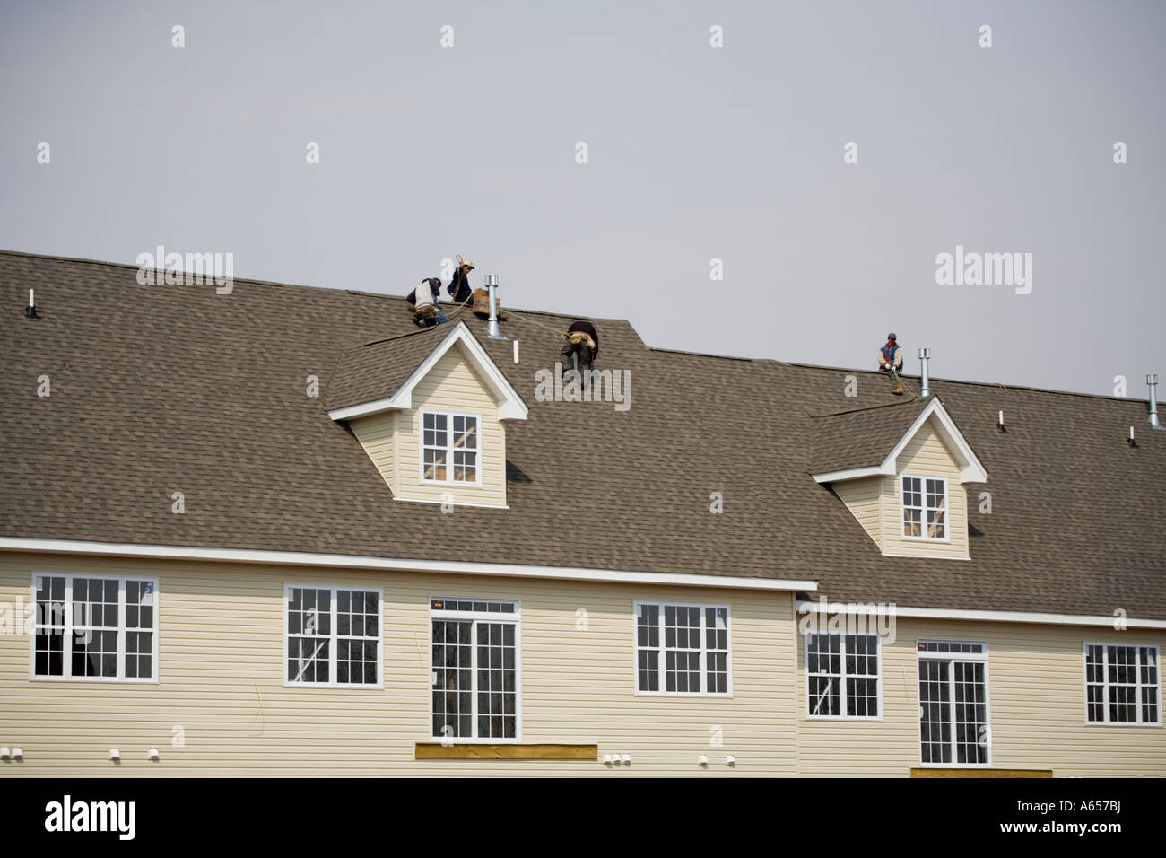 Immigrant Construction Worker Working on the Roof Stock Photo - Alamy