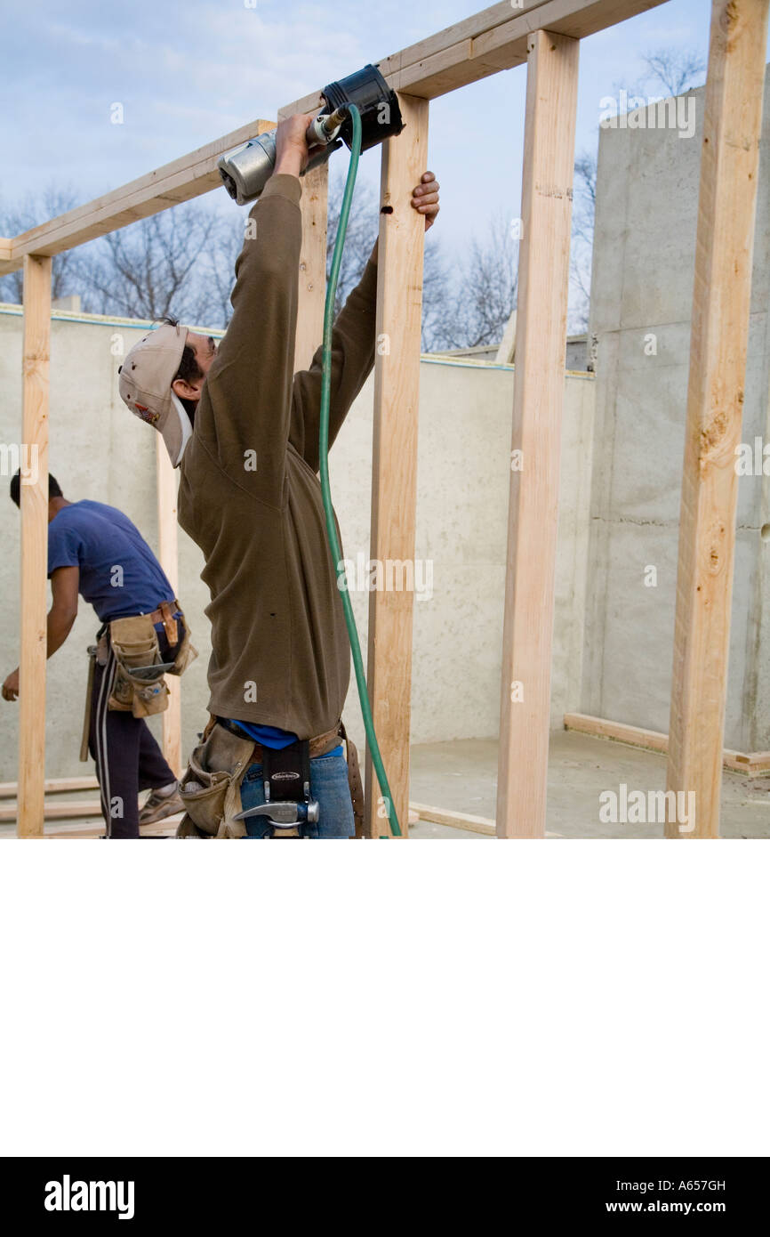 Immigrant Construction Worker Framing the House Stock Photo - Alamy