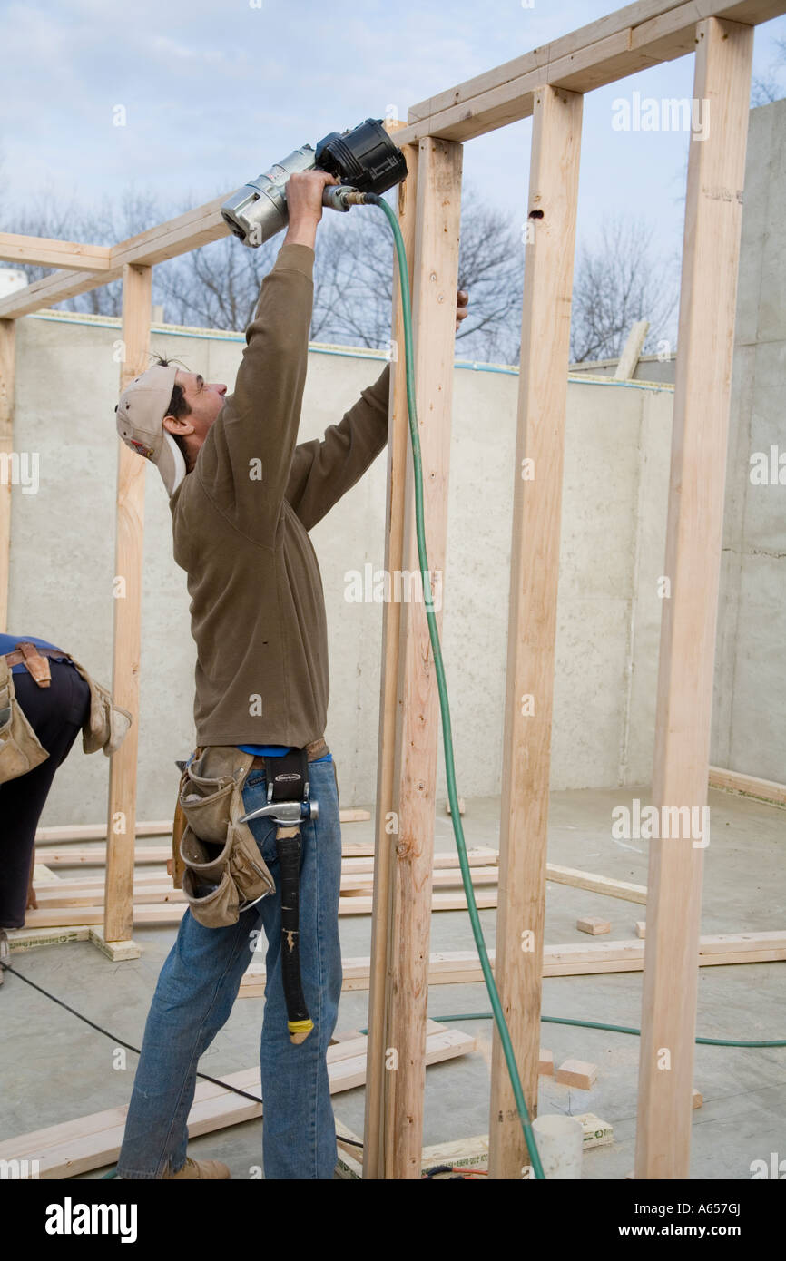 Immigrant Construction Worker Framing the House Stock Photo - Alamy