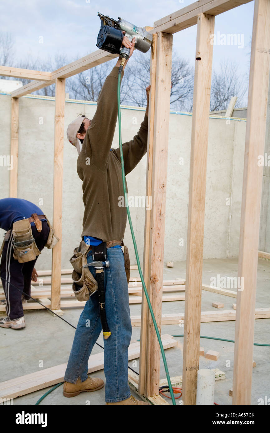 Immigrant Construction Worker Framing the House Stock Photo - Alamy
