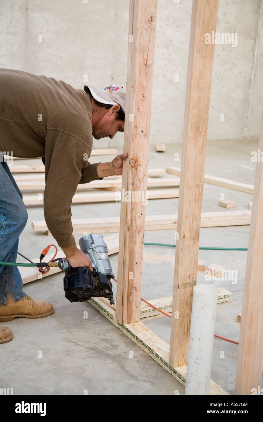 Immigrant Construction Worker Framing the House Stock Photo - Alamy