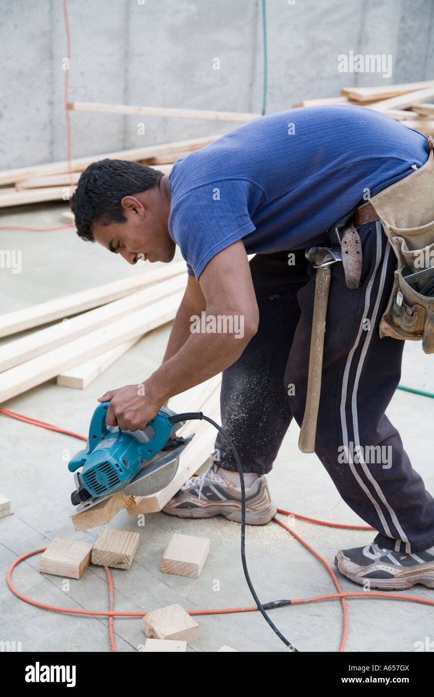 Immigrant Construction Worker Framing the House Stock Photo - Alamy