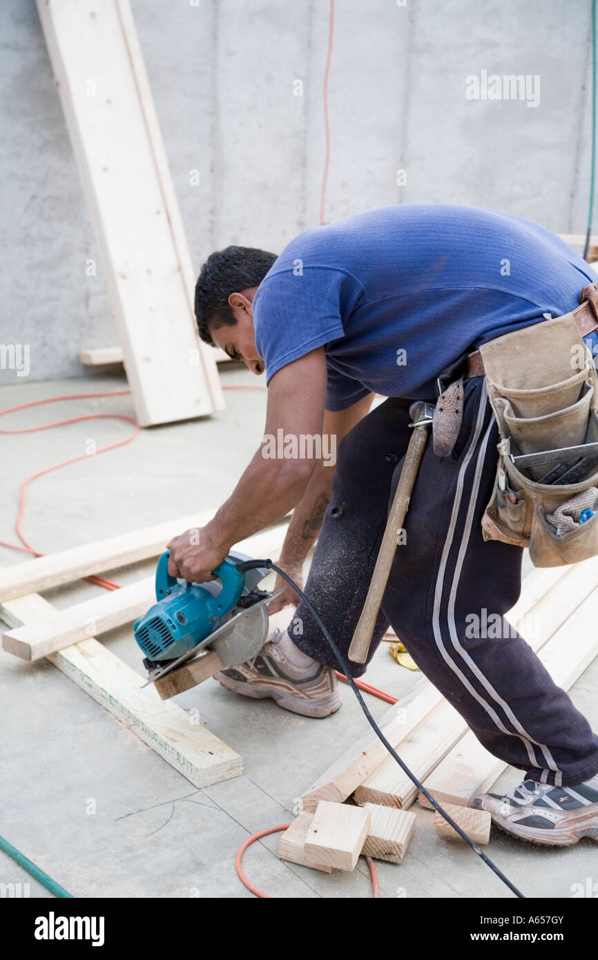 Immigrant Construction Worker Framing the House Stock Photo - Alamy