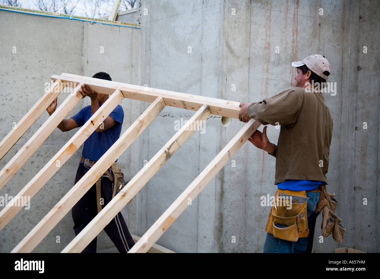 Immigrant Construction Worker Framing the House Stock Photo - Alamy
