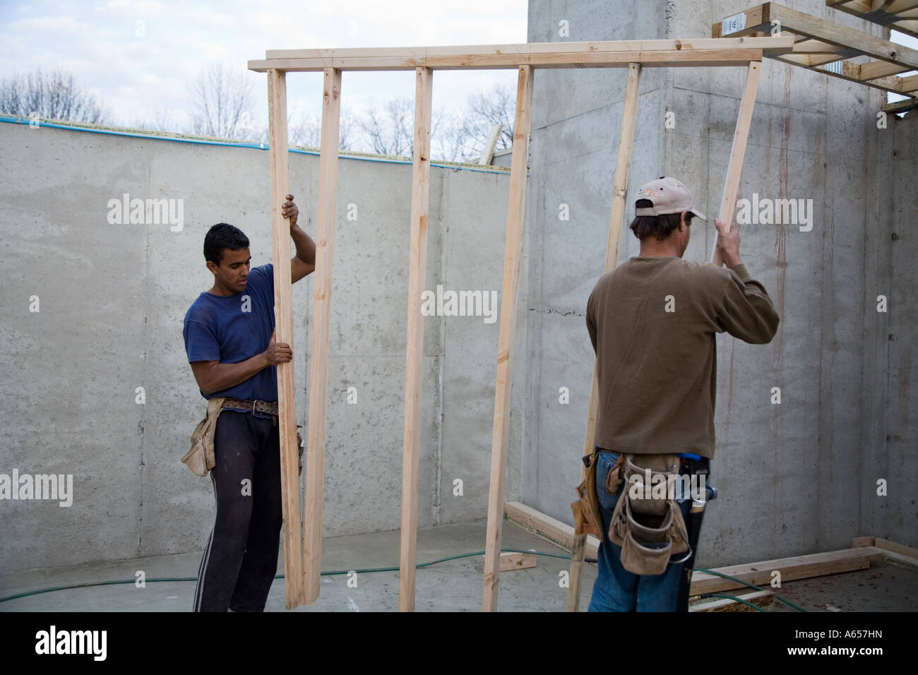 Immigrant Construction Worker Framing the House Stock Photo - Alamy