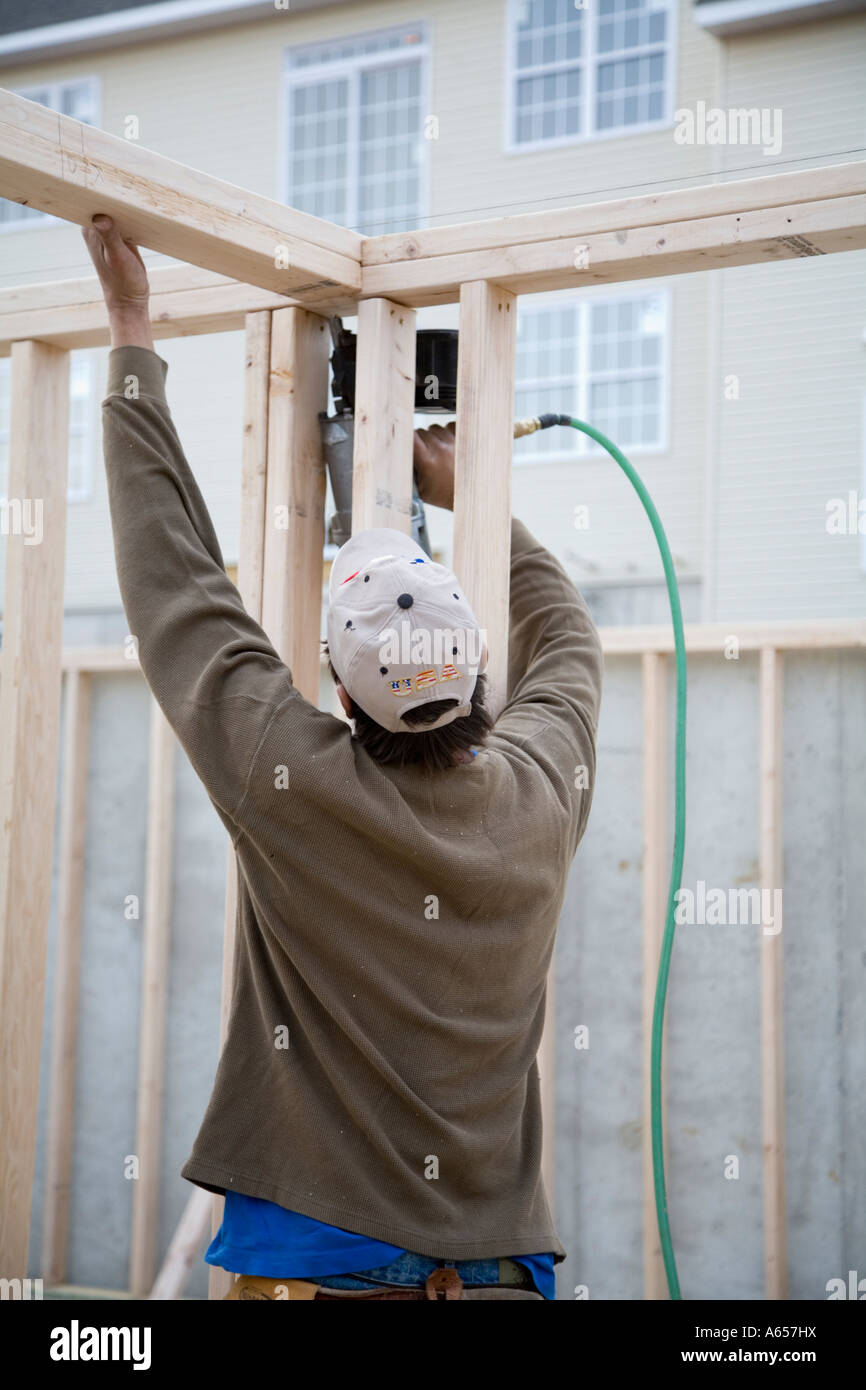 Immigrant Construction Worker Framing the House Stock Photo - Alamy