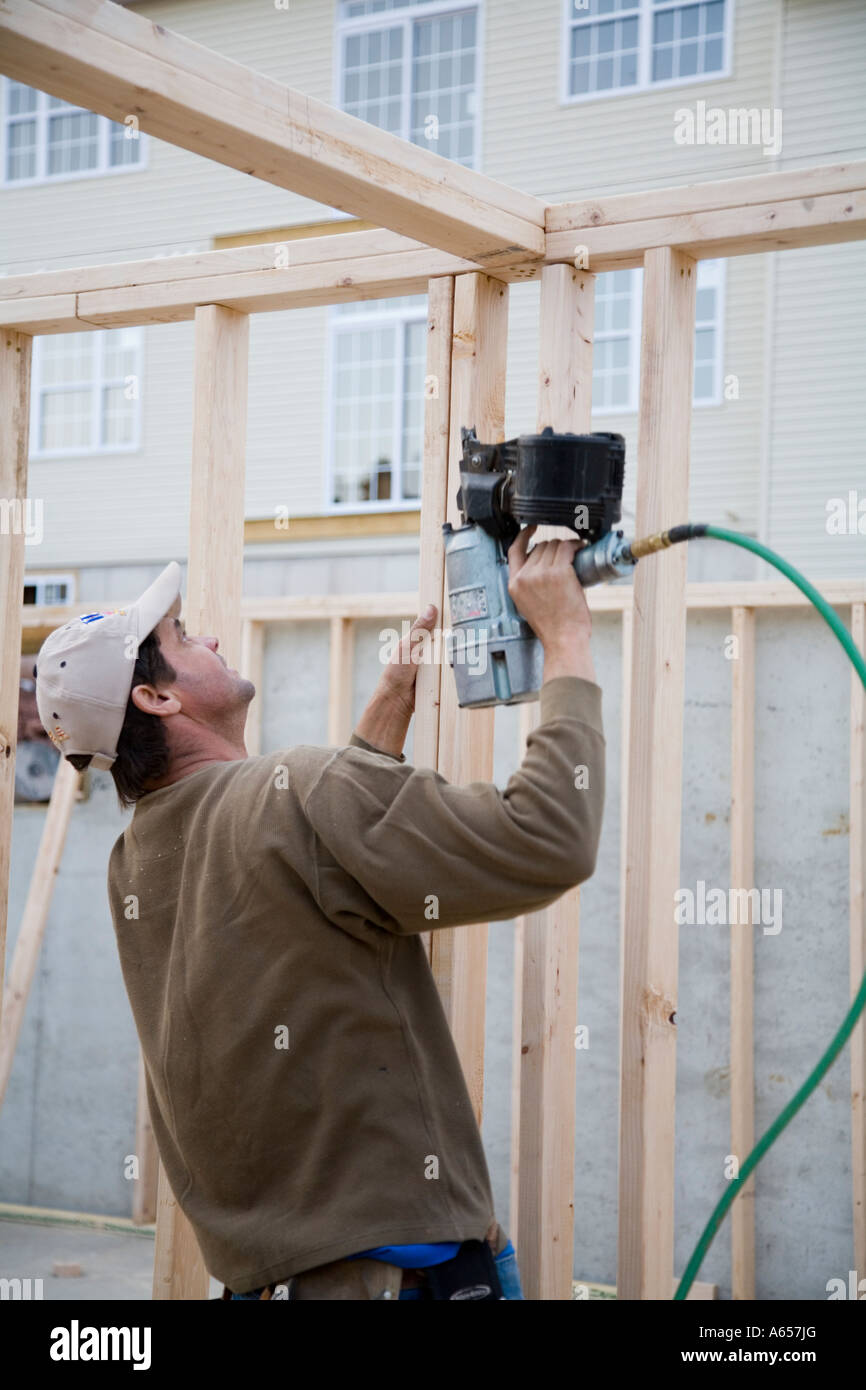 Immigrant Construction Worker Framing the House Stock Photo - Alamy