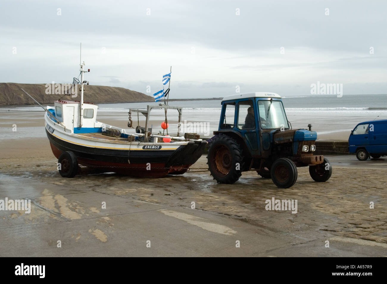 Filey Coble towed by the tractor onto the coble landing Stock Photo - Alamy