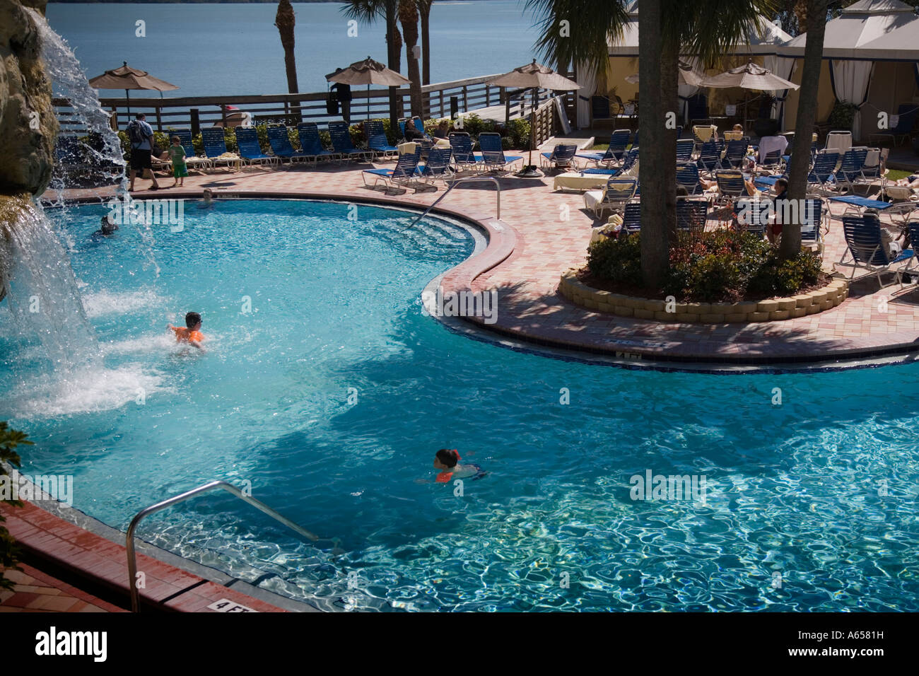 People swimming and relaxing at a resort Stock Photo - Alamy