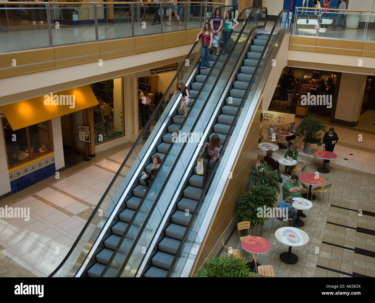 People on an escalator in a shopping mall Stock Photo - Alamy
