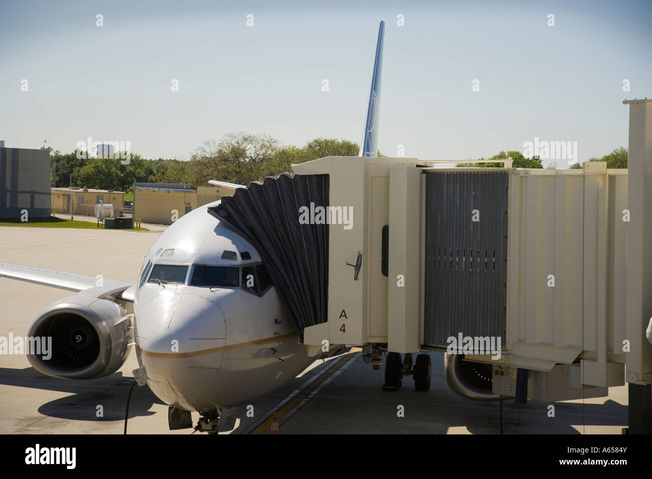 Passenger jet being serviced at the gate Stock Photo - Alamy