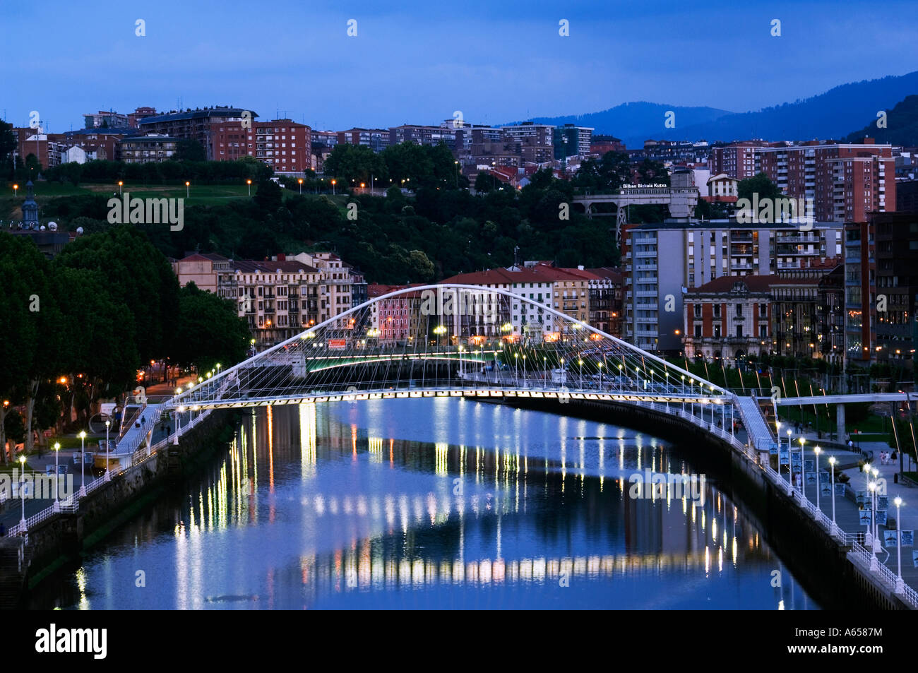 Zubizuri Bridge over Bibao River lit up at night Stock Photo - Alamy