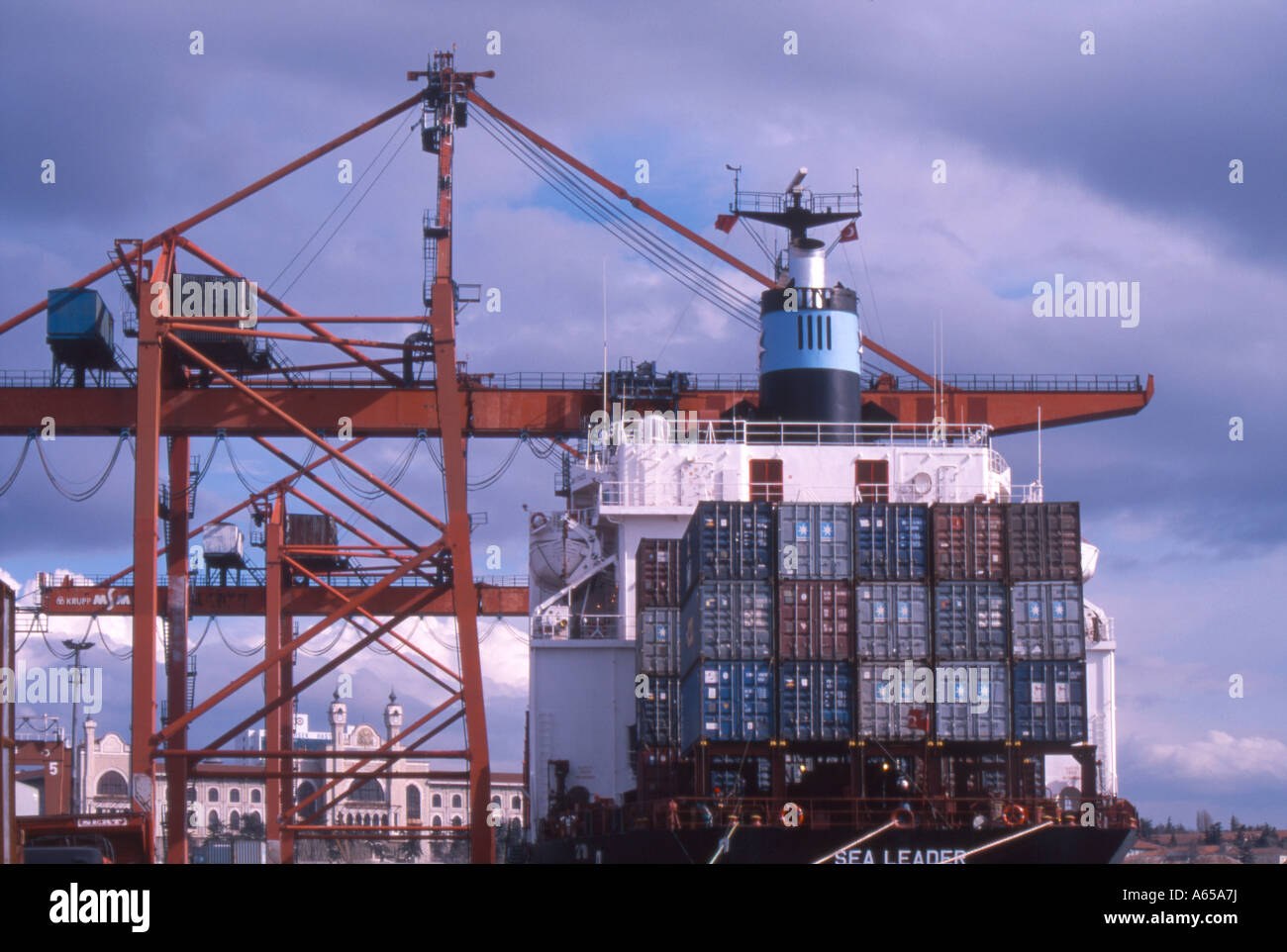 Cargo ship loading and unloading containers at the freight terminal ...