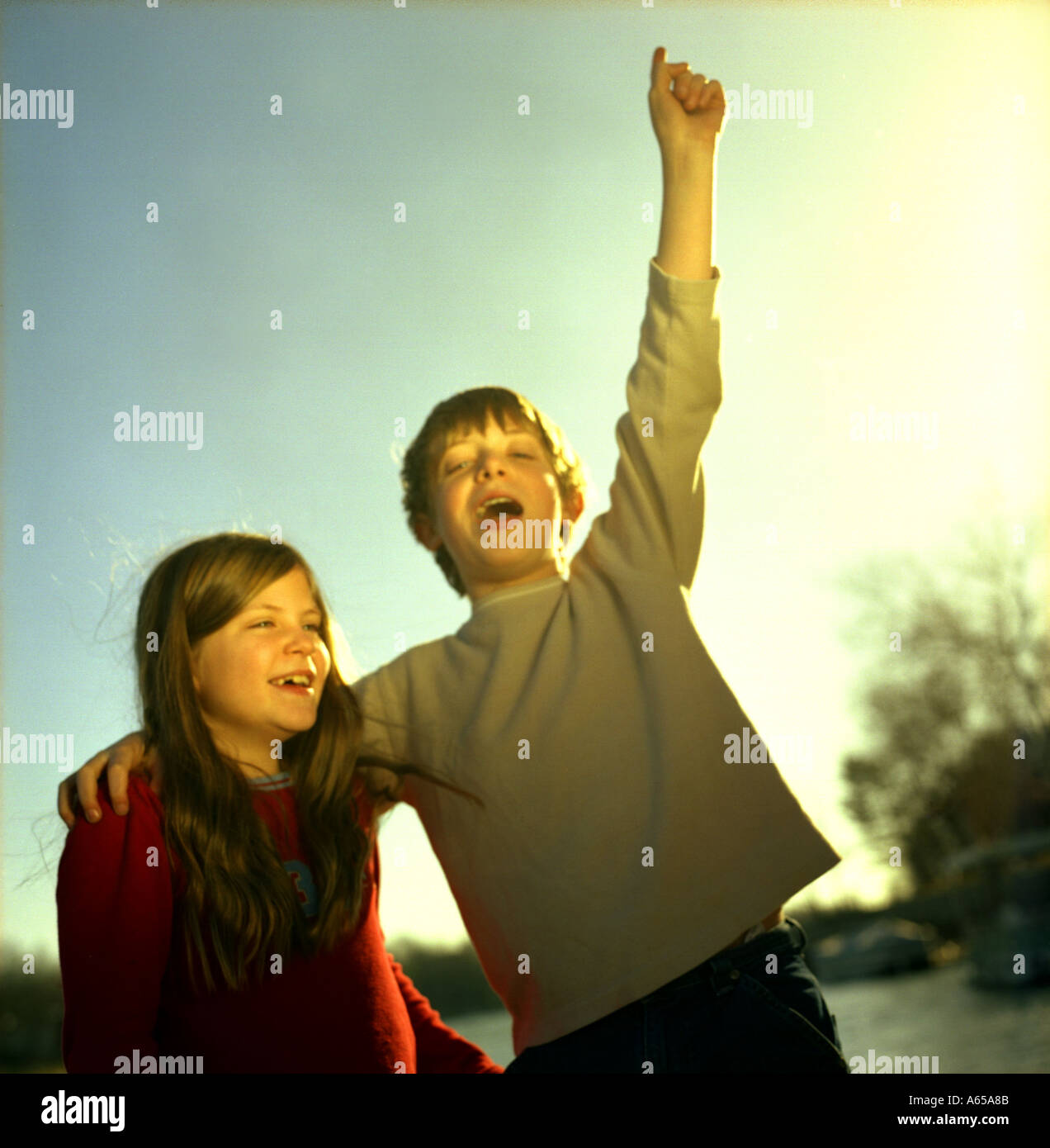 Girl and Boy Cheering Stock Photo - Alamy