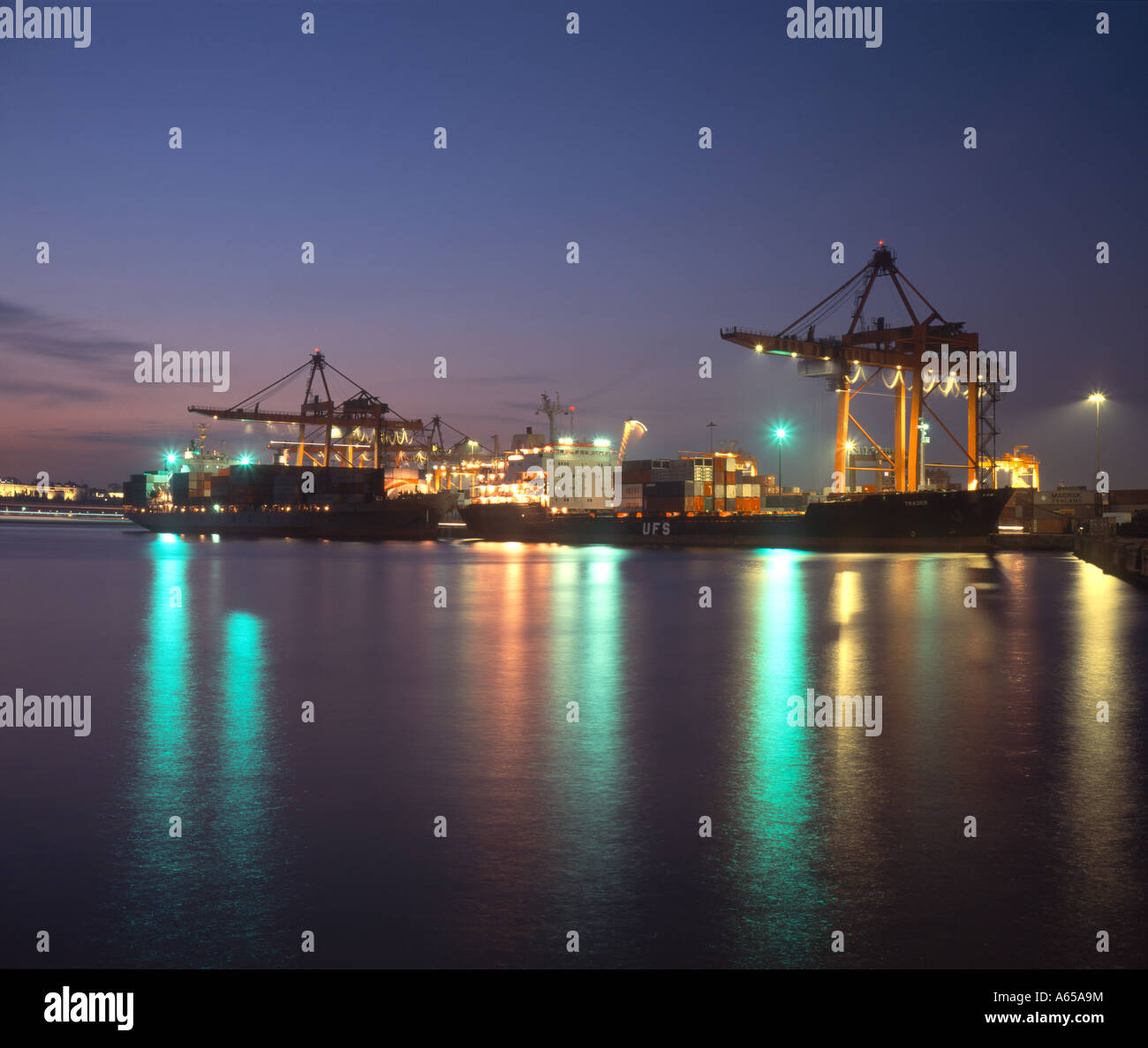 Cargo ships loading and unloading containers at freight terminal ...