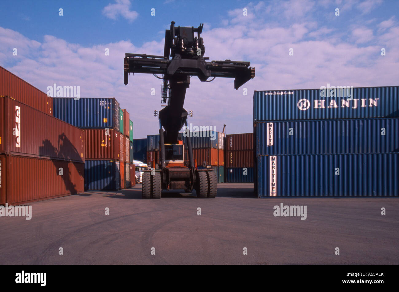 Stacker vehicle lifting container at freight terminal Istanbul Turkey ...