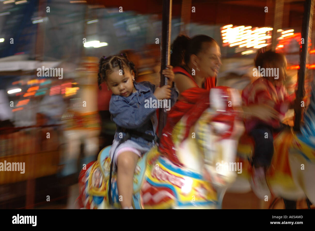 A Little Girl Is Riding Carousel At Coney Island Stock Photo - Alamy