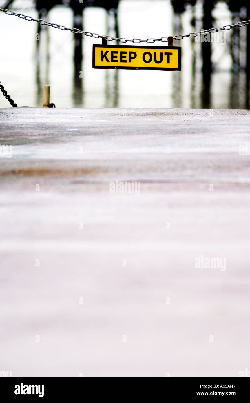 Yellow keep out sign on Blackpool promenade Stock Photo - Alamy