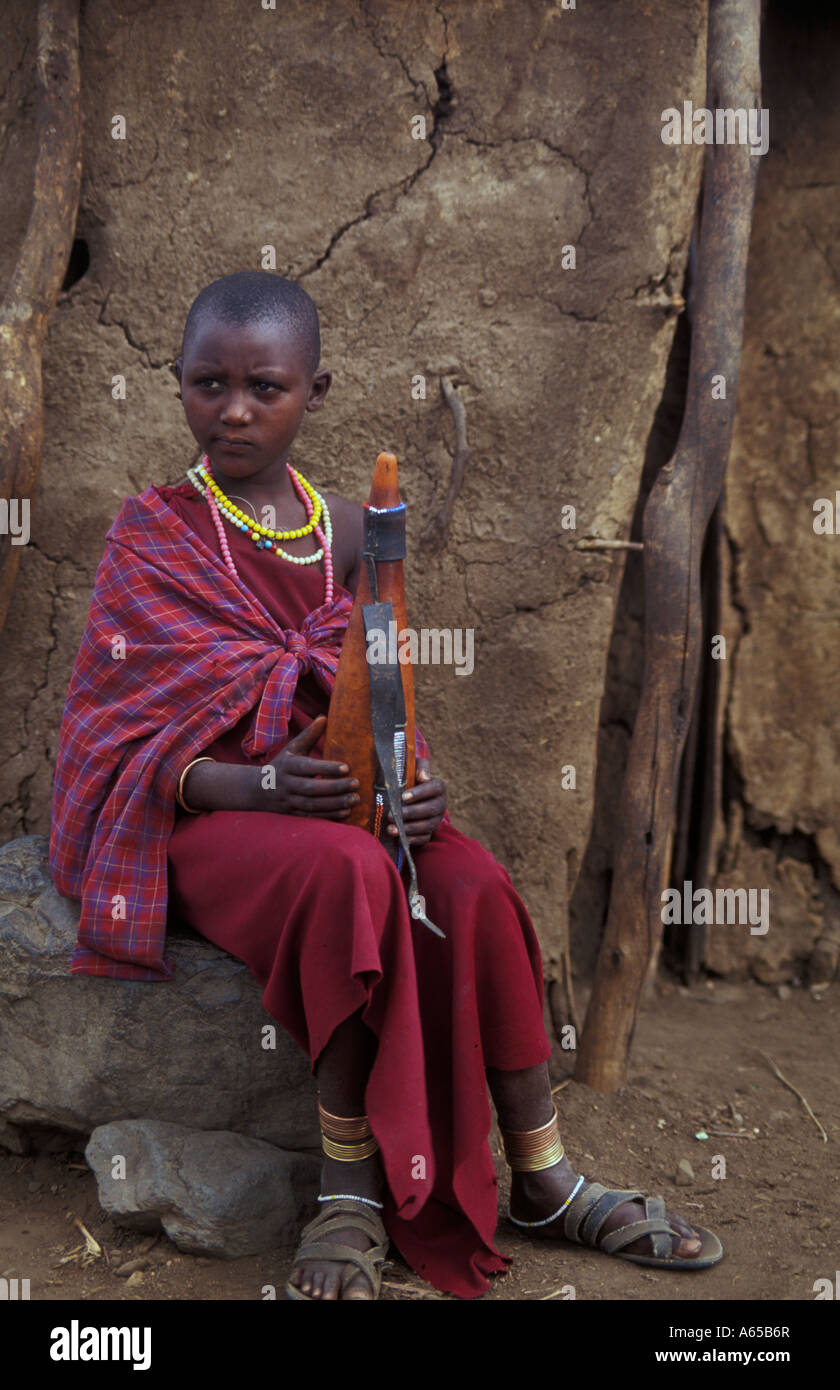 Maasai girl drinking milk from a tradtional Maasai milk bottle made ...