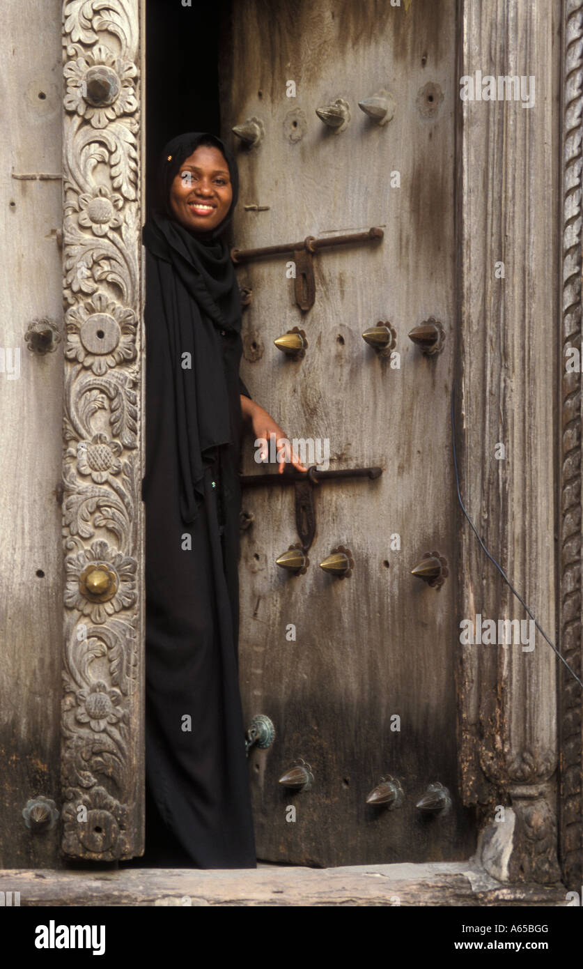 Swahili woman wearing a traditional bui bui standing in a Zanzibar ...