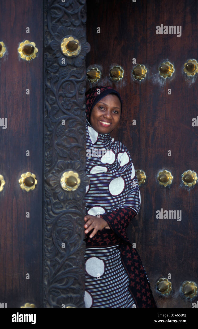 Swahili woman standing in a Zanzibar doorway Zanzibar Tanzania Stock ...