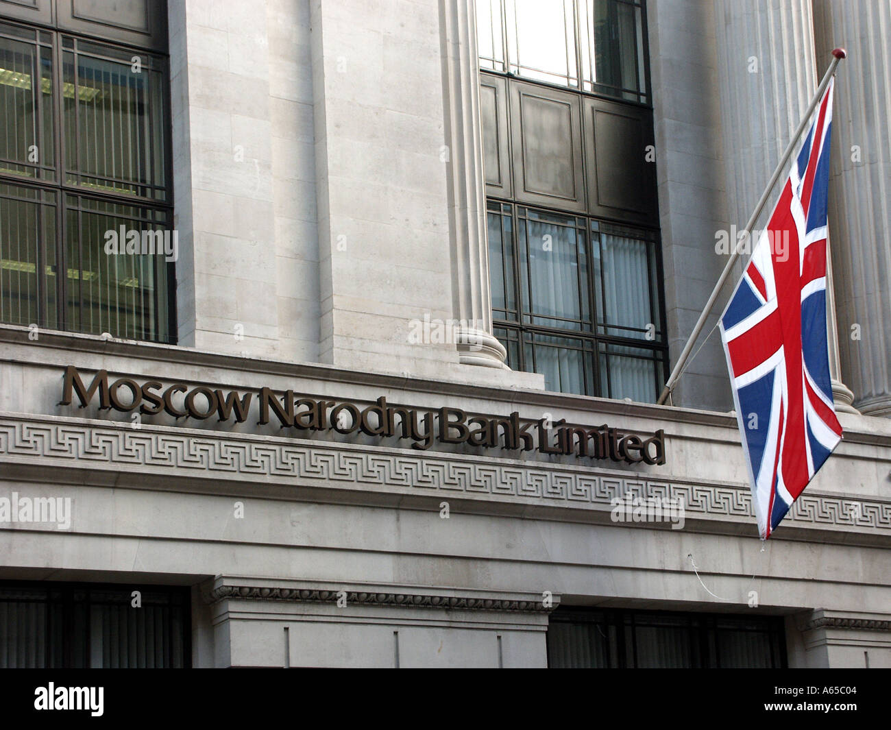 Union Jack flag & sign above exterior view of Moscow Narodny Bank ...