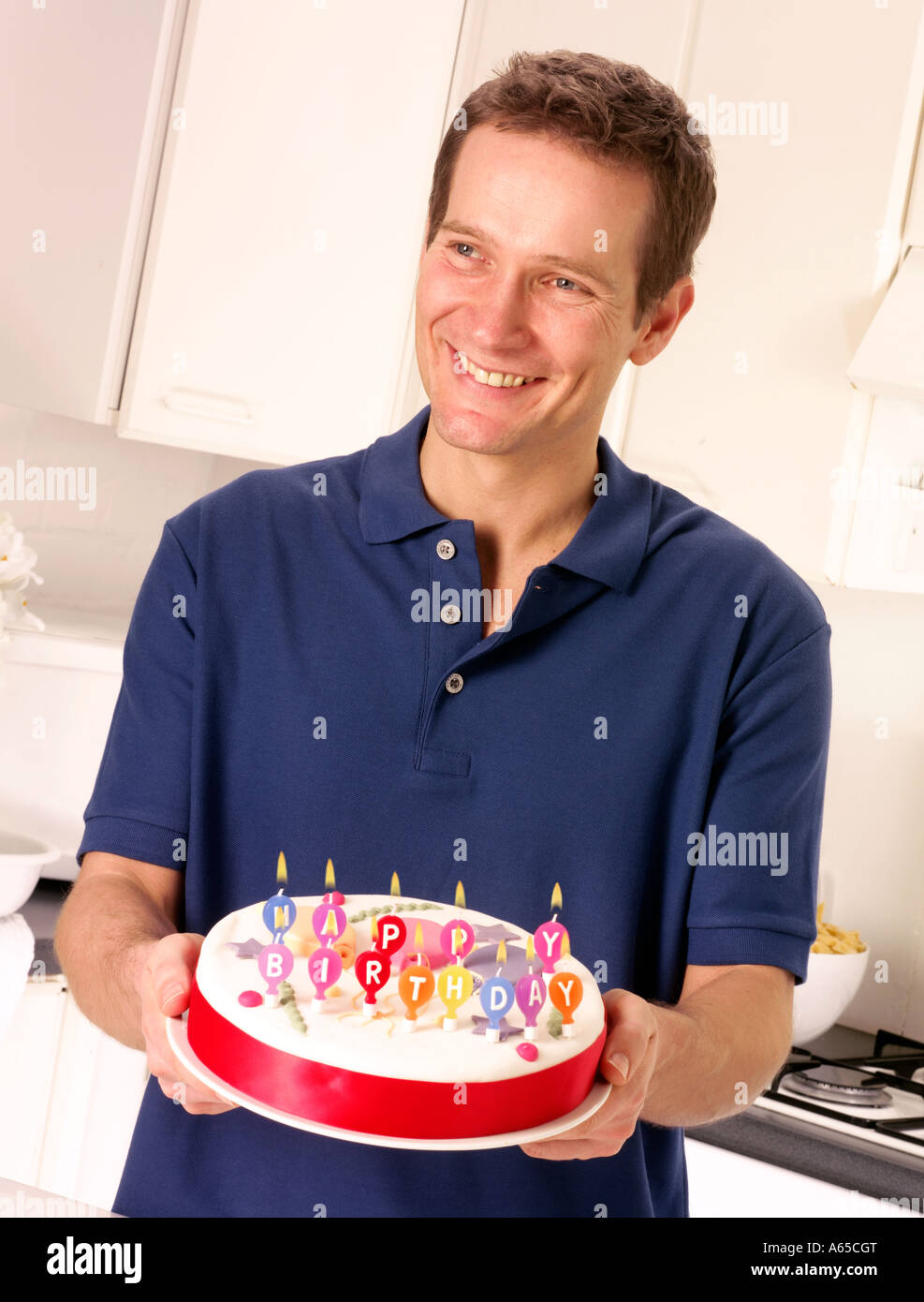 MAN WITH BIRTHDAY CAKE Stock Photo - Alamy