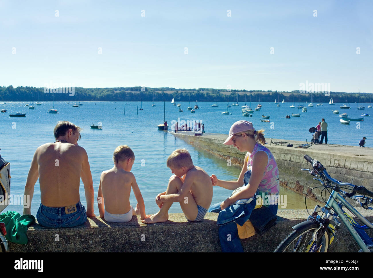 PEOPLE SUNBATHING ON RANCE RIVERBANK SAINT-SULIAC BRITTANY FRANCE Stock ...