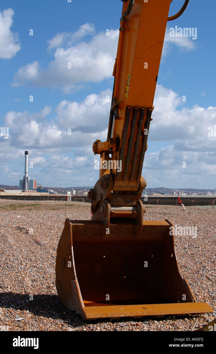 Yellow JCB JS330 digger arm on shingle beach at Shoreham-by-Sea, West ...
