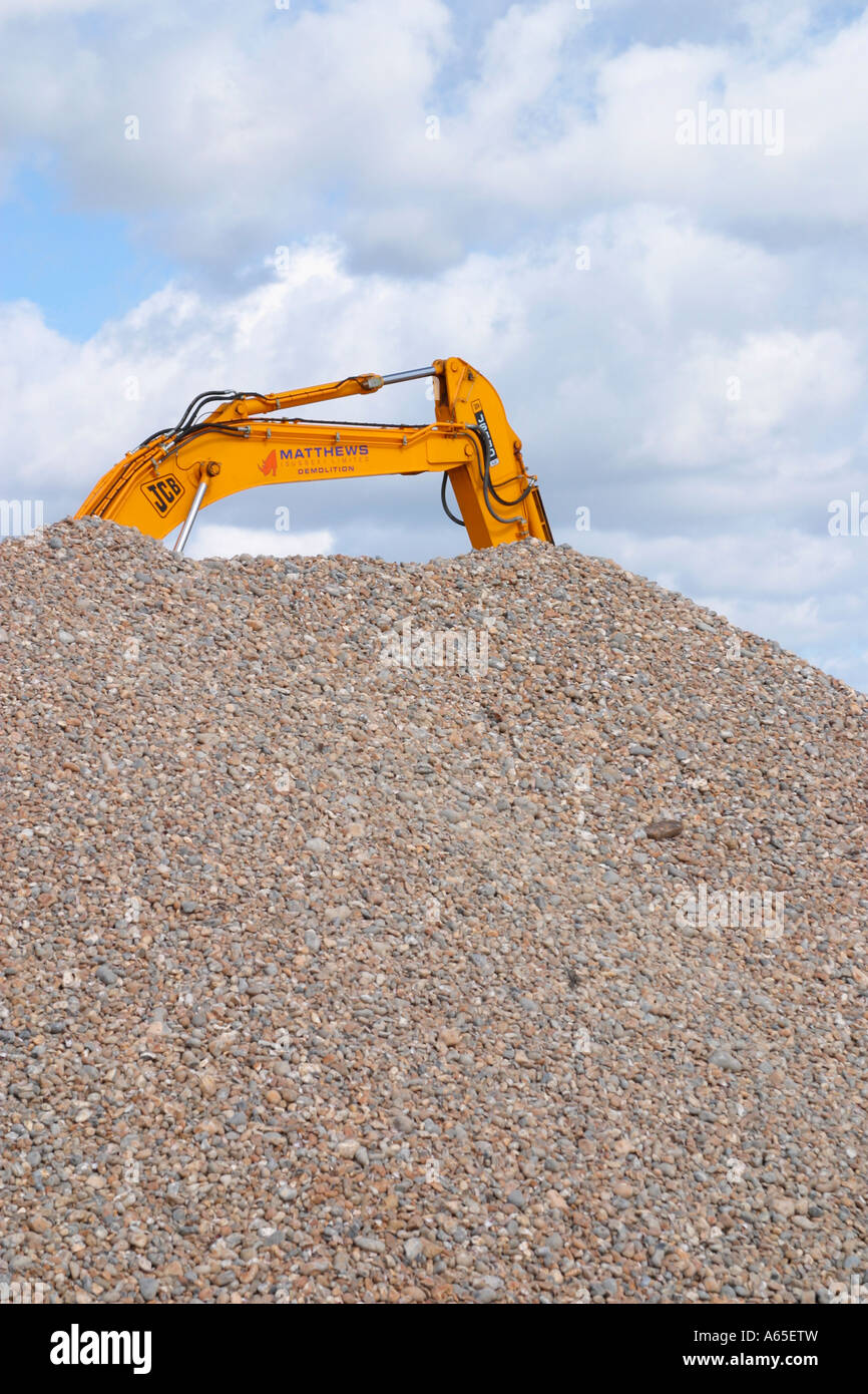 Large yellow JCB digger on shingle beach Shoreham by Sea, West Sussex ...
