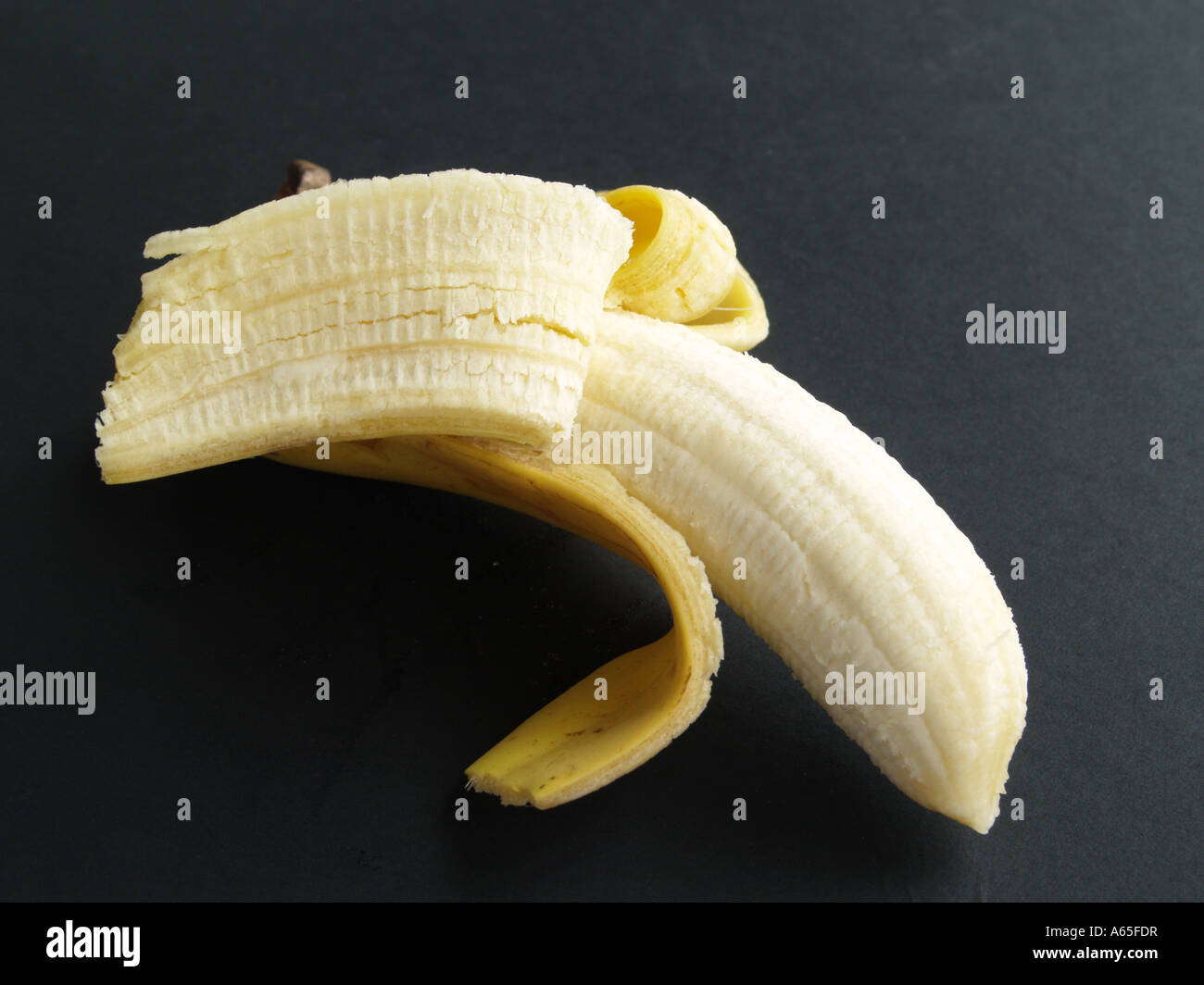 Banana half peeled Stock Photo - Alamy