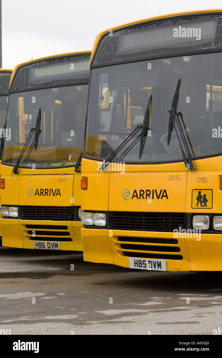 fleet of Arriva wales yellow painted school buses parked in depot Stock ...