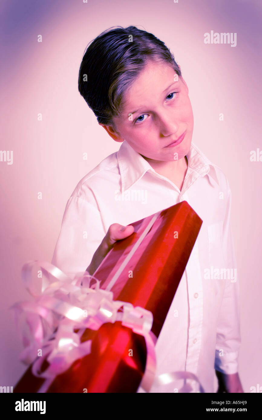 Boy handing out gift Stock Photo - Alamy