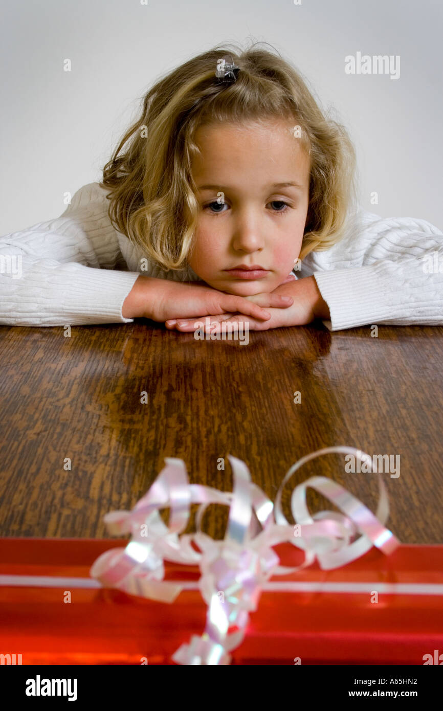 Girl waiting to open gift Stock Photo - Alamy